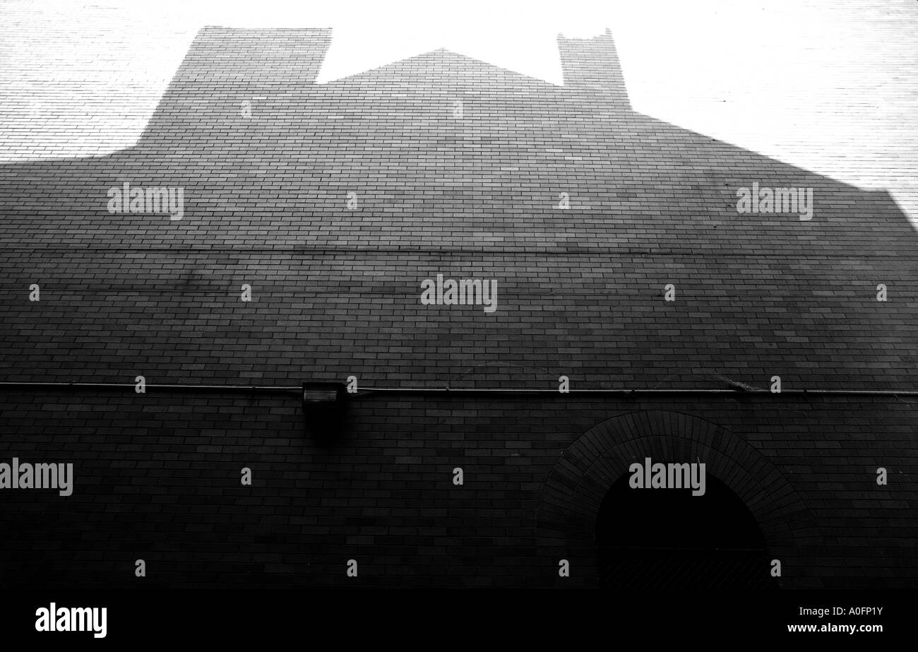 shadow cast by building on brick brownstone building in chinatown Stock ...
