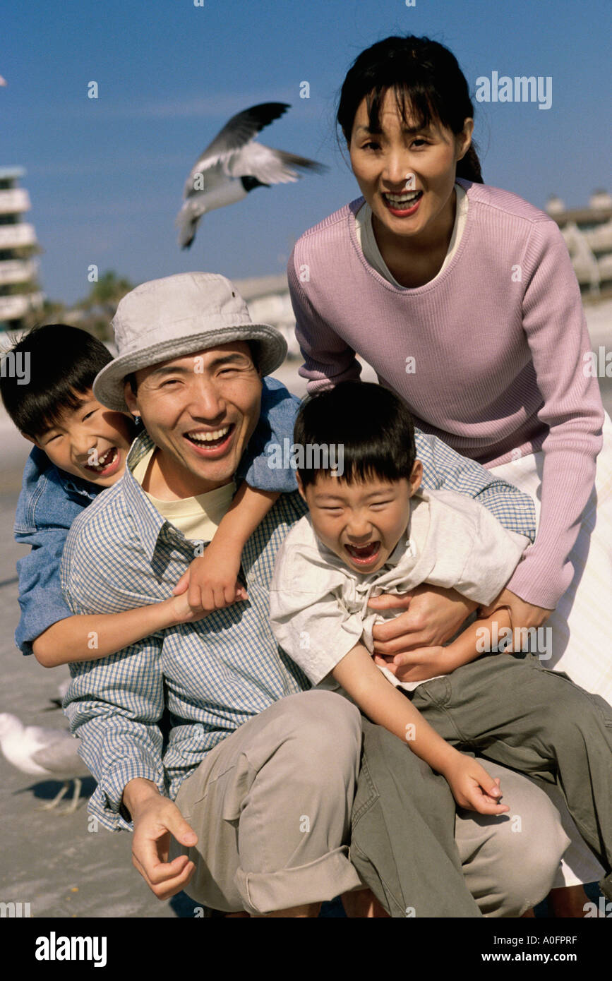 Portrait of parents smiling with their two sons Stock Photo - Alamy