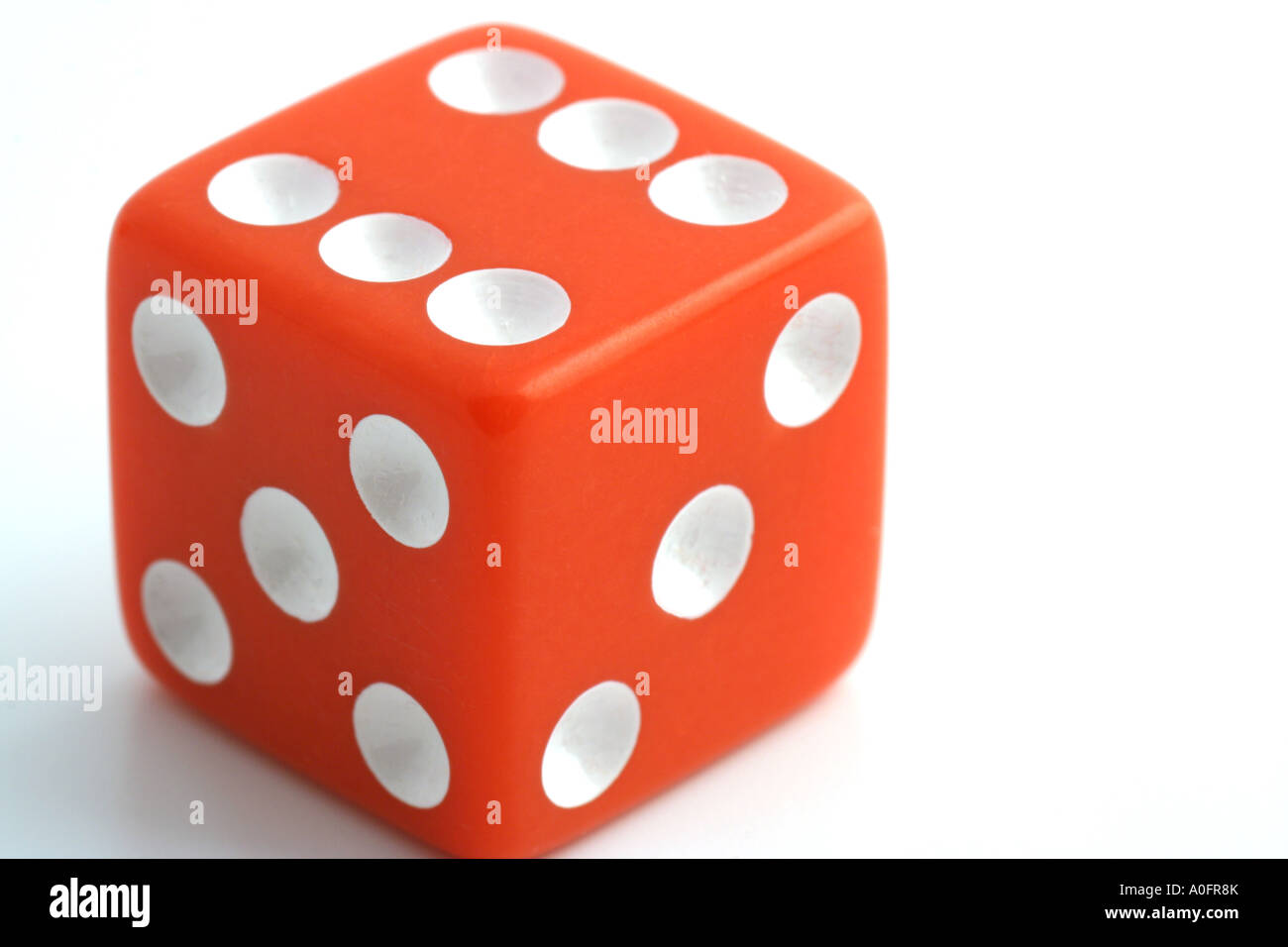 Single red die with white spots Stock Photo - Alamy