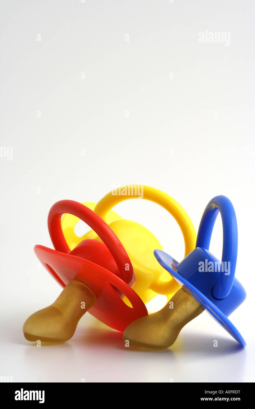 Red blue and yellow pacifiers Stock Photo - Alamy