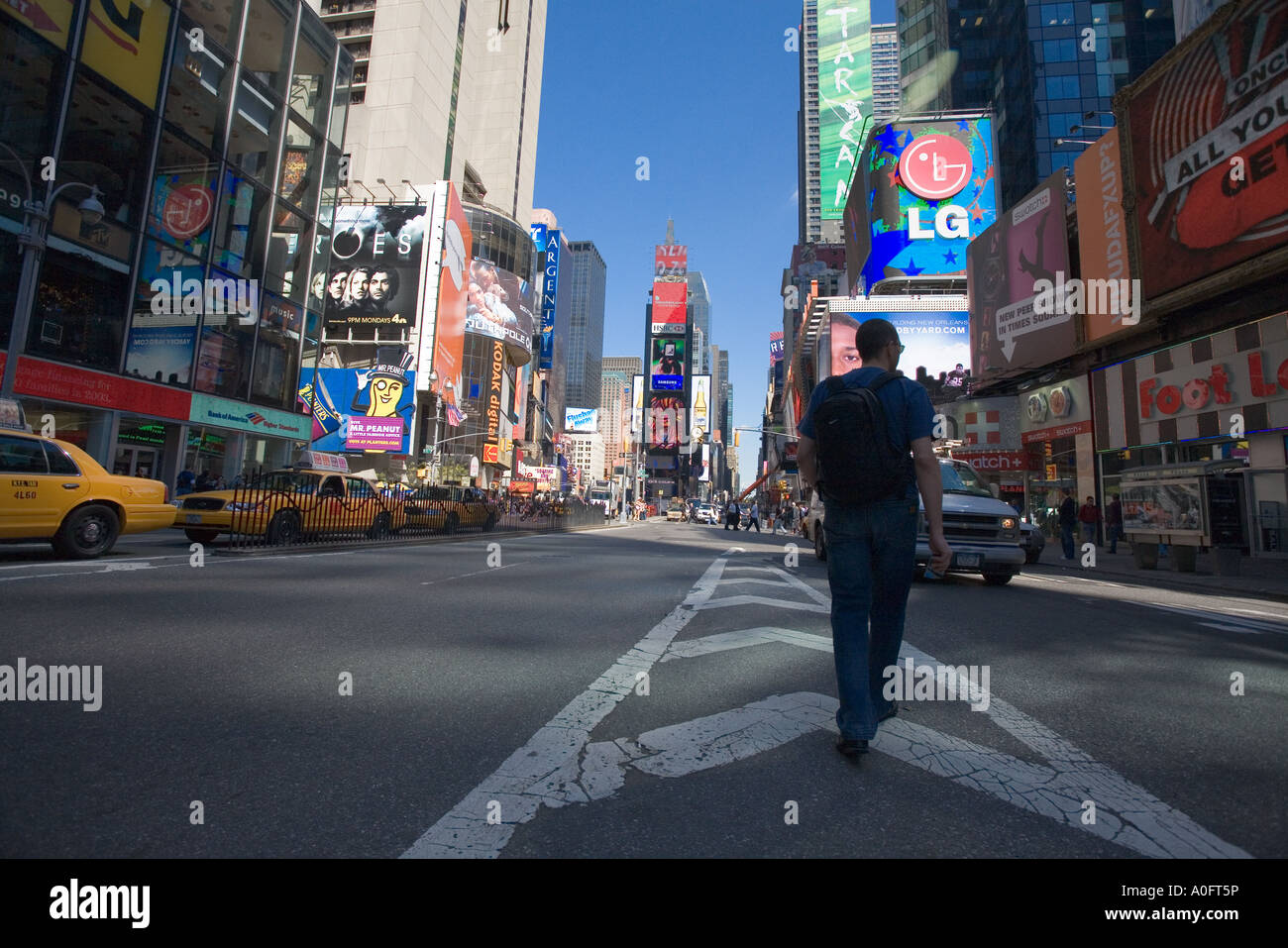 man walking in times square ny in clear morning with sun Stock Photo ...