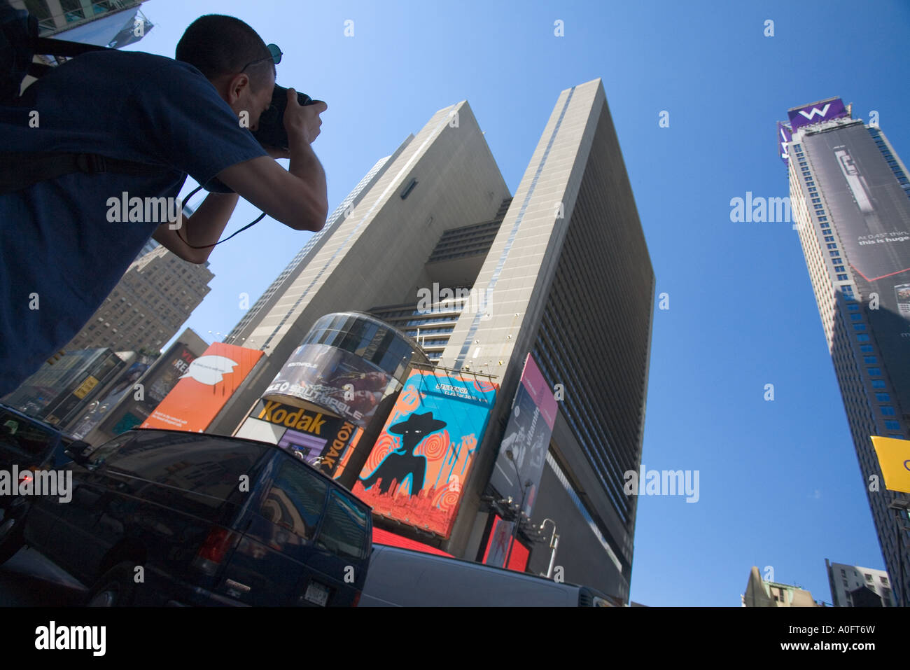 man taking picture of building in times square on clear day Stock Photo ...