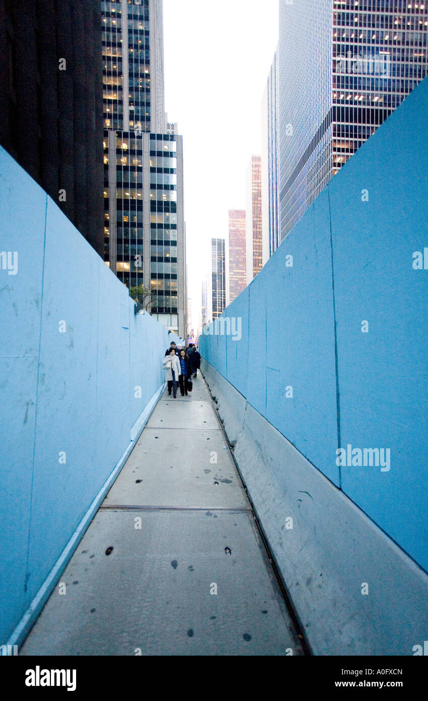 construction work on seventh avenue people walking between wood walls ...
