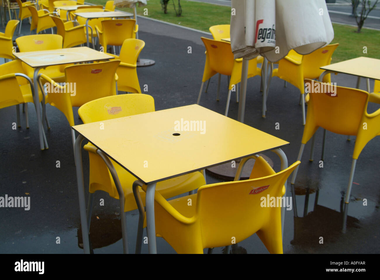 Yellow café tables and chairs Stock Photo - Alamy