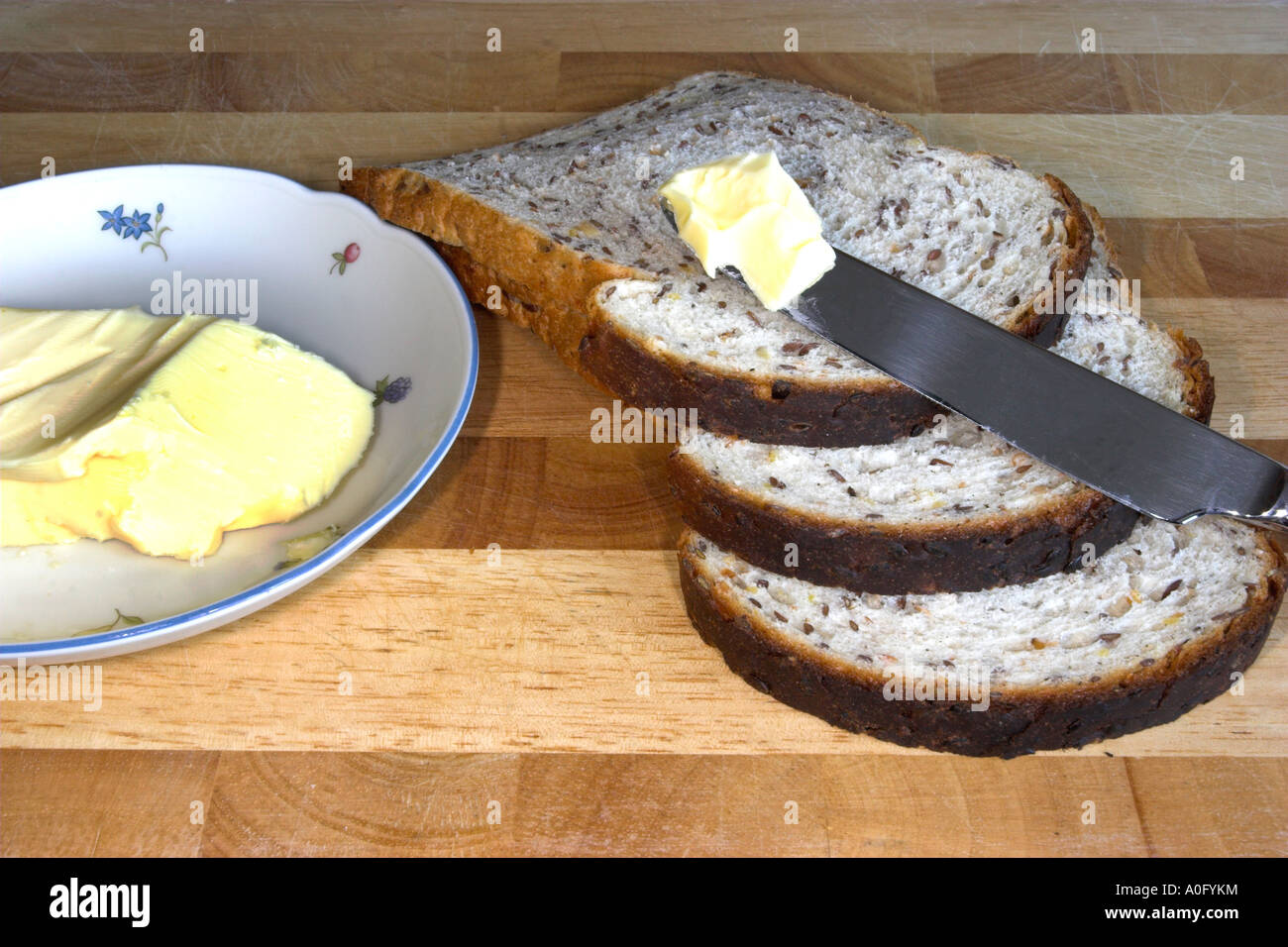 Butter ready to be spread on slices of brown bread Stock Photo - Alamy