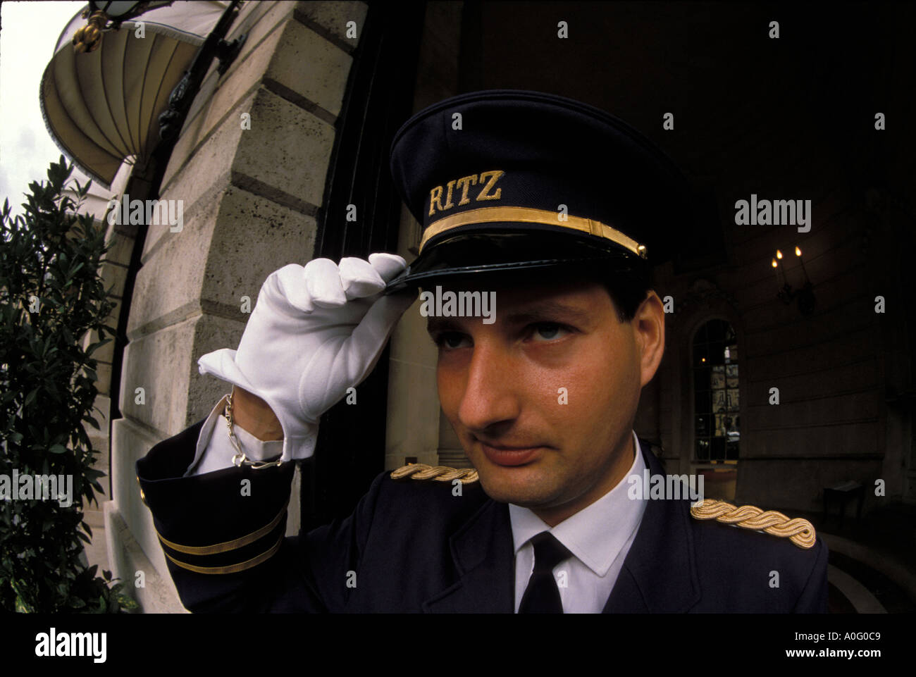 The doorman at the famous Ritz Hotel in Paris France welcomes guests at ...