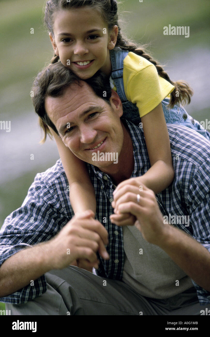 Father carrying his daughter on his back Stock Photo - Alamy