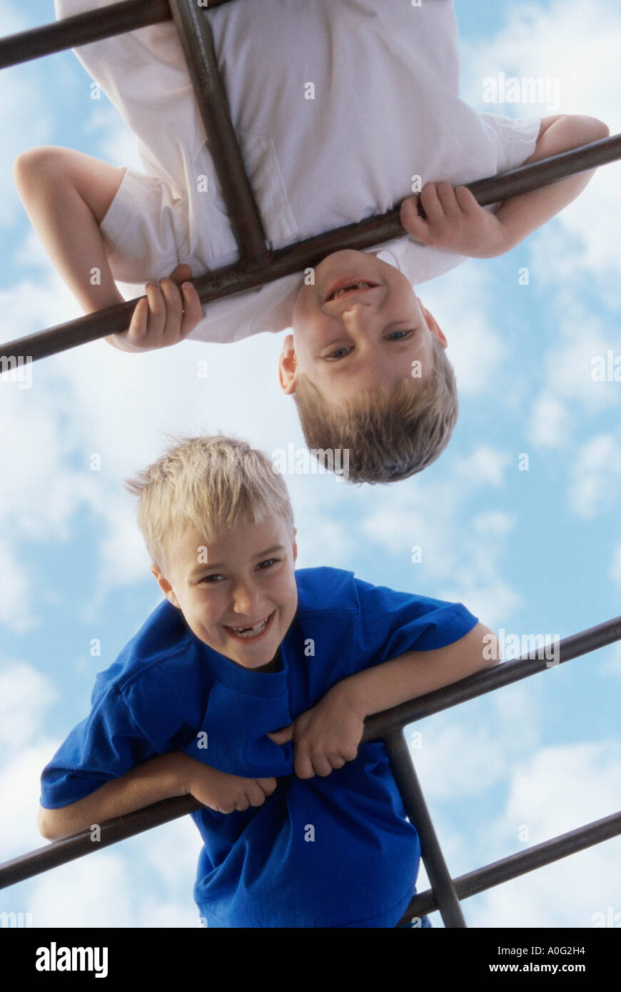 Portrait of two boys playing on monkey bars Stock Photo - Alamy