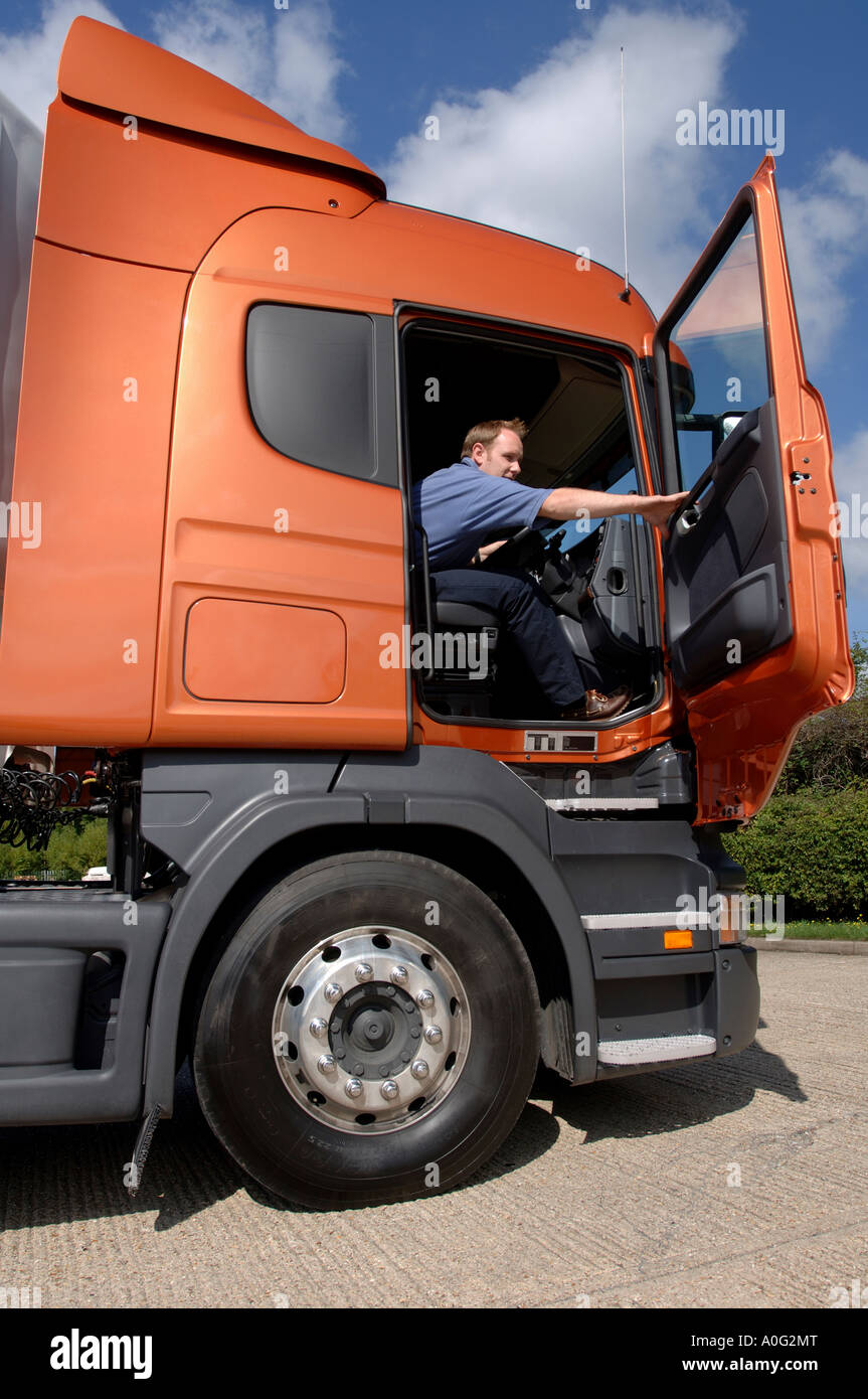 lorry driver climbing into the cab of a scania r500 v8 lorry Stock ...