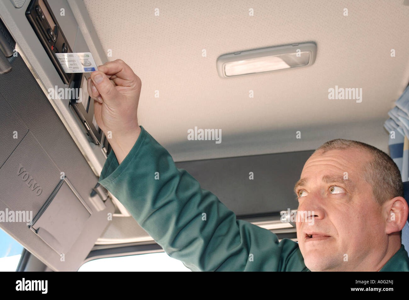 driver using a digital tachometer on board a lorry Stock Photo - Alamy