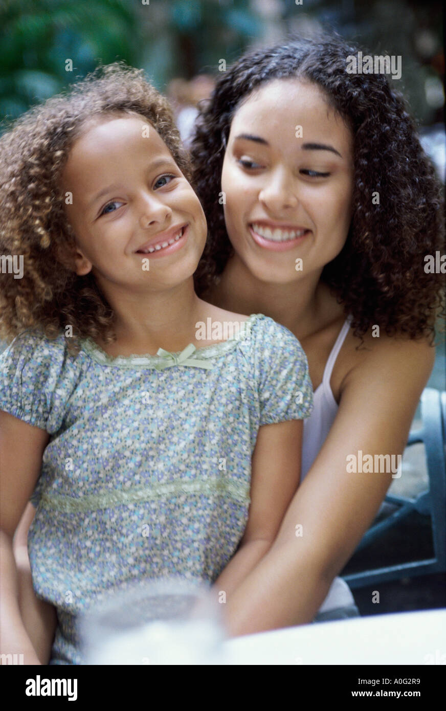 Mother hugging her daughter Stock Photo - Alamy