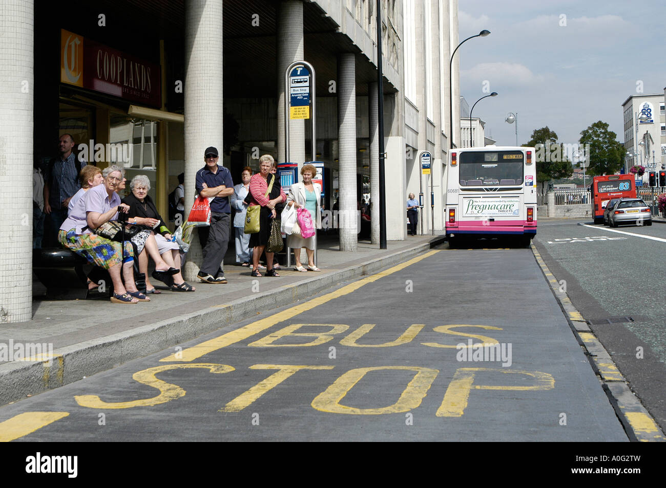 Passengers waiting at a bus stop in Sheffield Stock Photo - Alamy