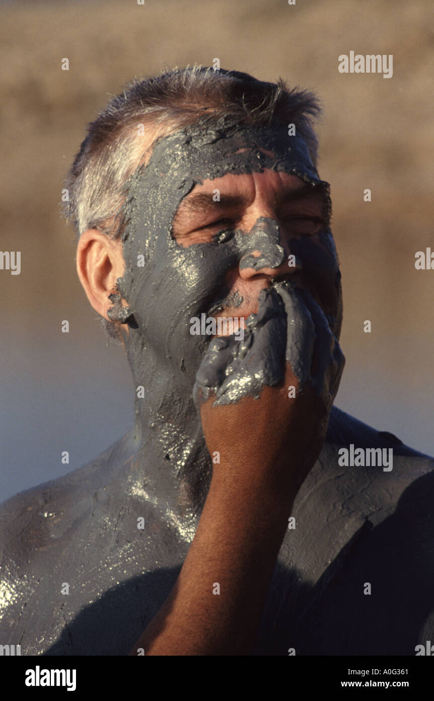 man with theraputic Dead Sea mud on His face in Jordan on the Dead Sea ...