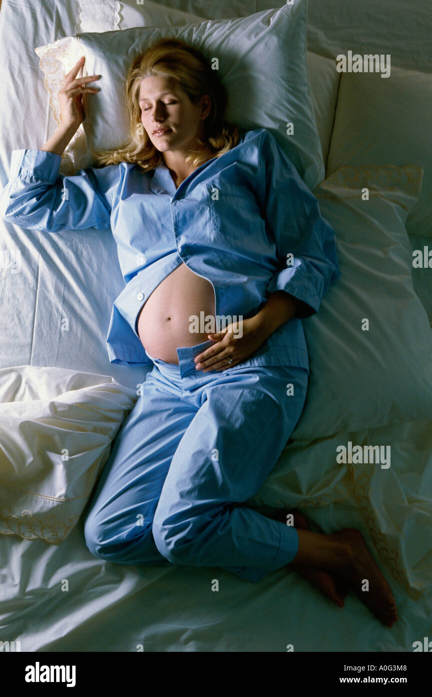 High angle view of a pregnant woman sleeping on a bed Stock Photo - Alamy