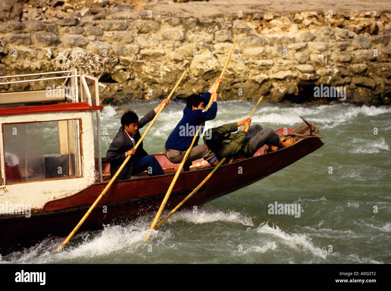 Yangtze River, Chongqing, China -Boatman poling boat upstream on the ...