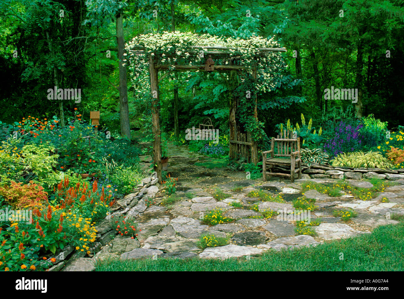 rustic cedar twig arbor with blooming vine by flagstone patio in flower ...