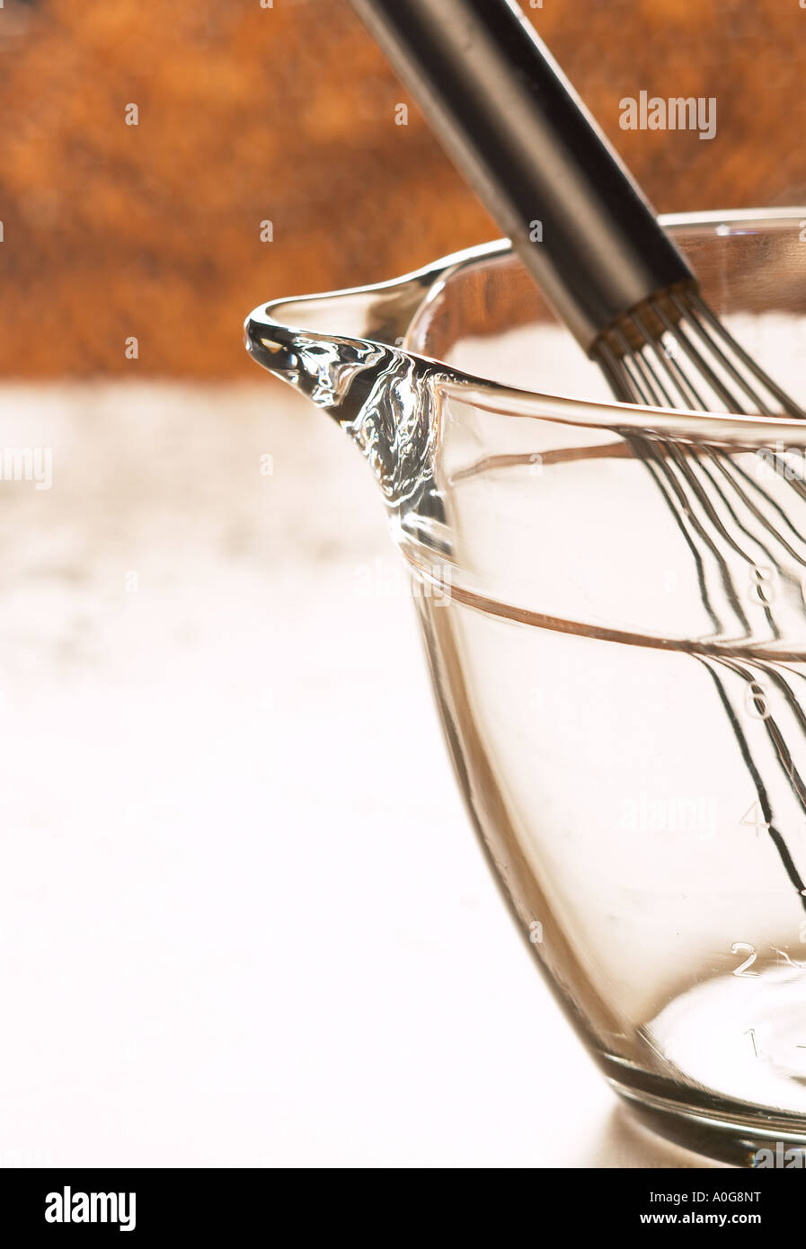 Kitchen With Metal Whisk And Clear Glass Measuring Bowl Stock Photo - Alamy