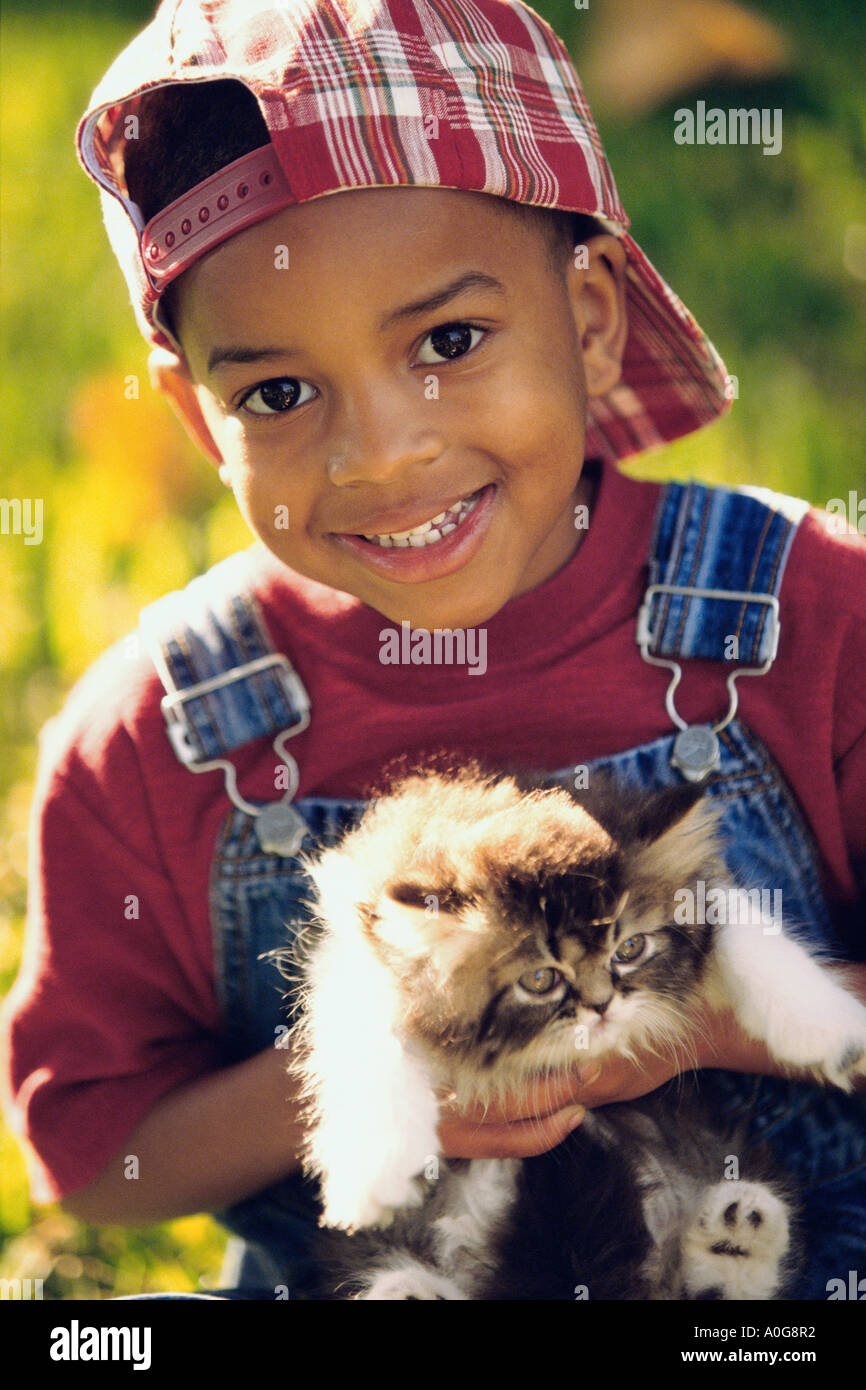 Portrait of a boy holding a cat Stock Photo - Alamy