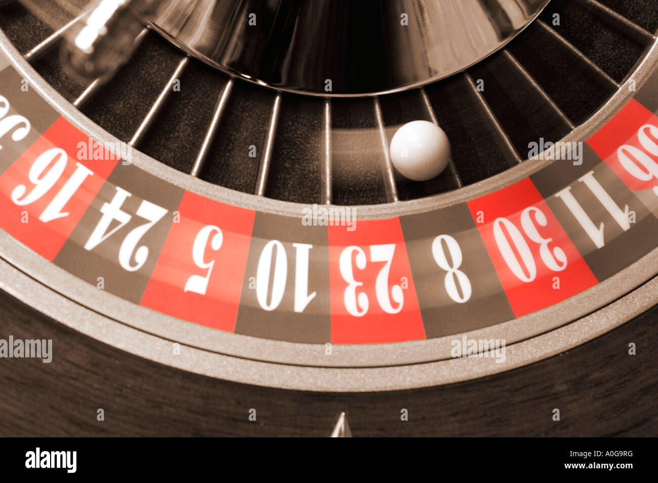 Roullette wheel spinning with ball in number eight slot sepia toned ...
