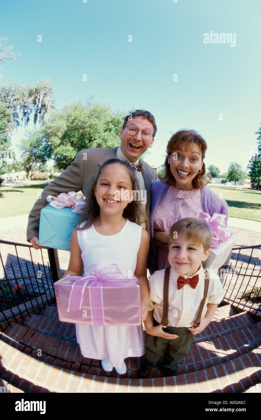 Portrait of parents standing with their son and daughter Stock Photo ...