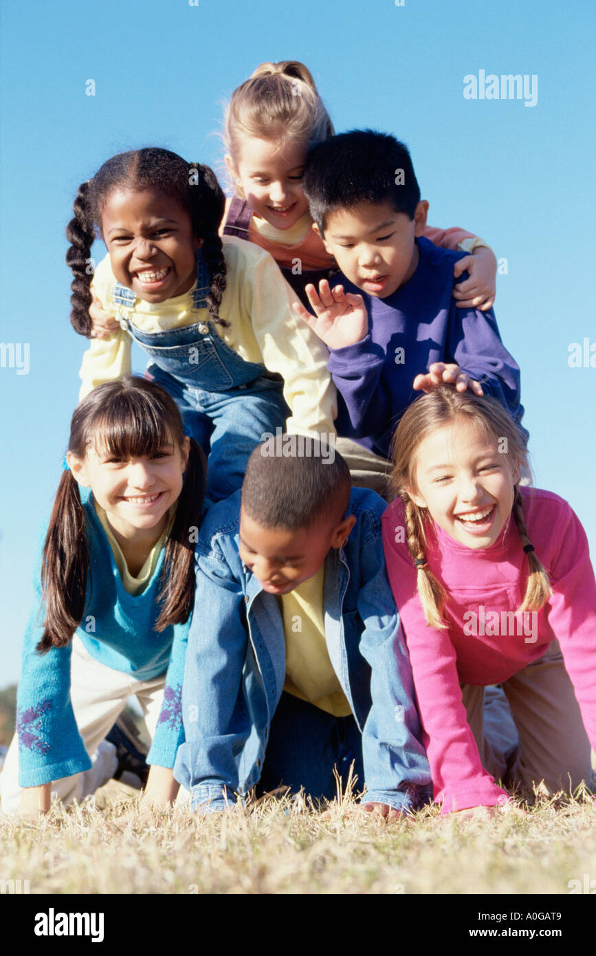 Portrait of a group of children making a human pyramid Stock Photo - Alamy