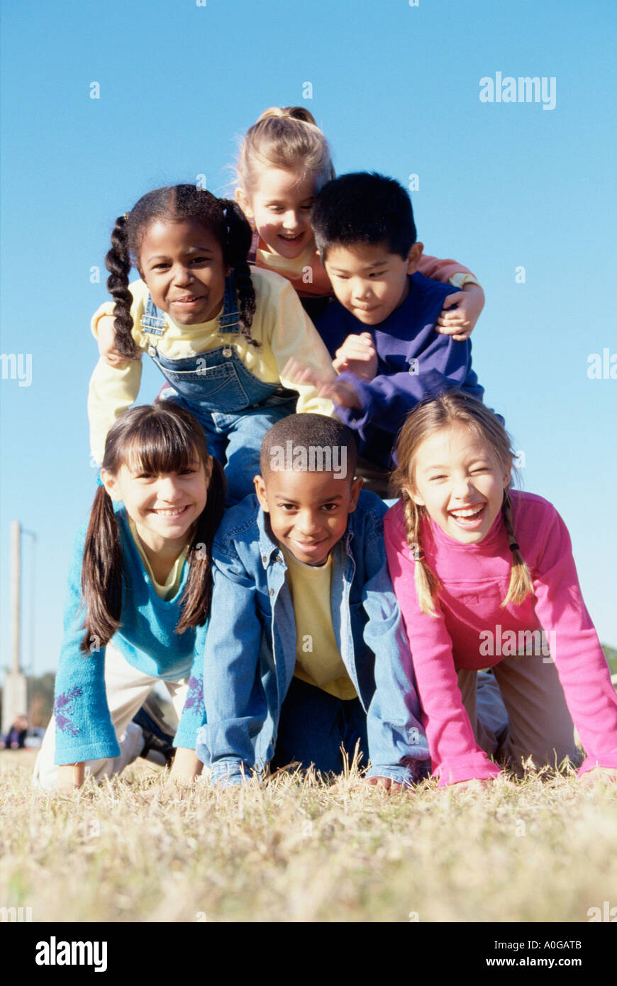 Portrait of a group of children making a human pyramid Stock Photo - Alamy