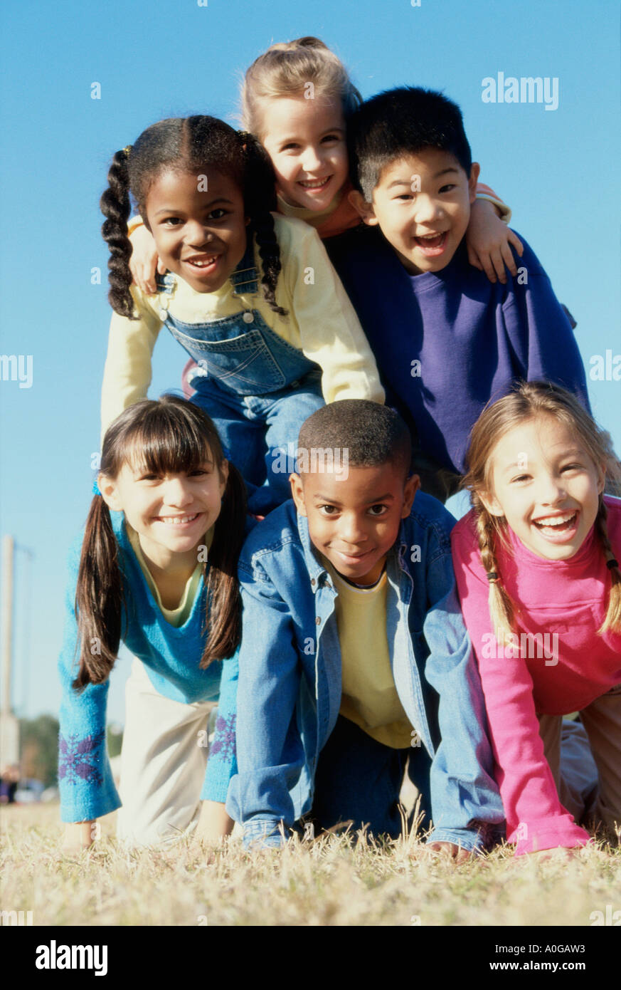 Portrait of a group of children making a human pyramid Stock Photo - Alamy