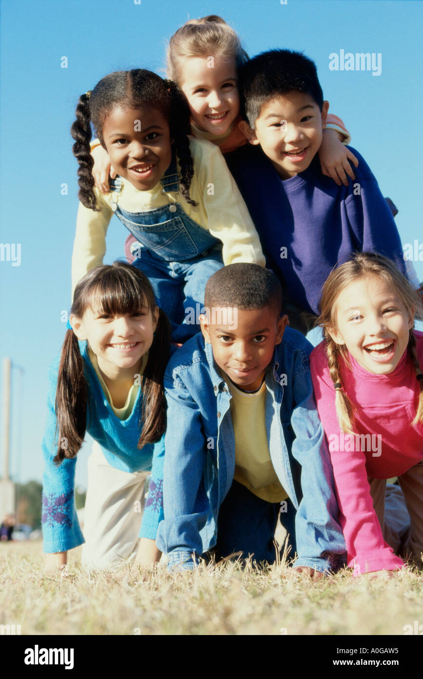 Portrait of a group of children making a human pyramid Stock Photo - Alamy