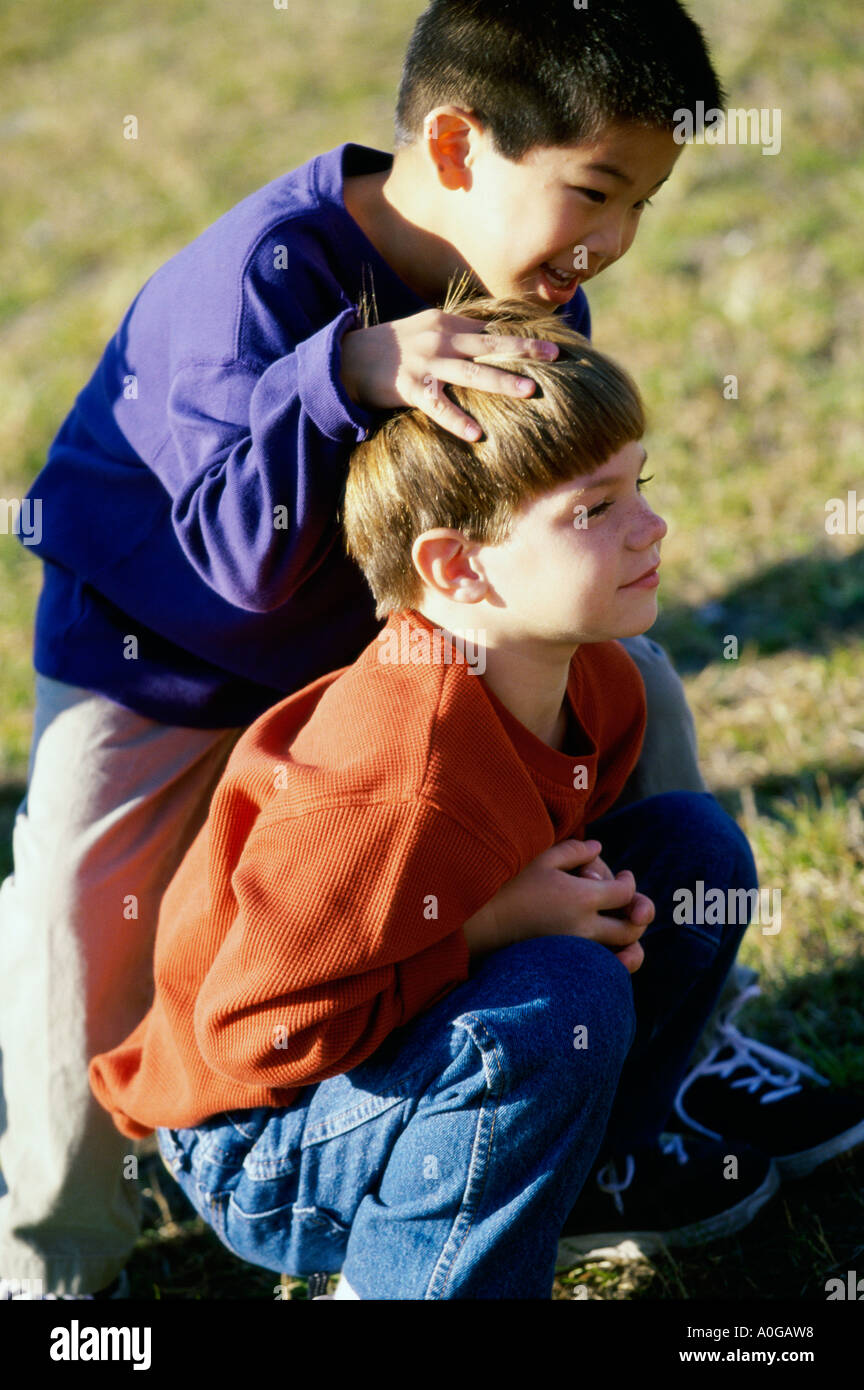 Side profile of two boys playing Stock Photo - Alamy