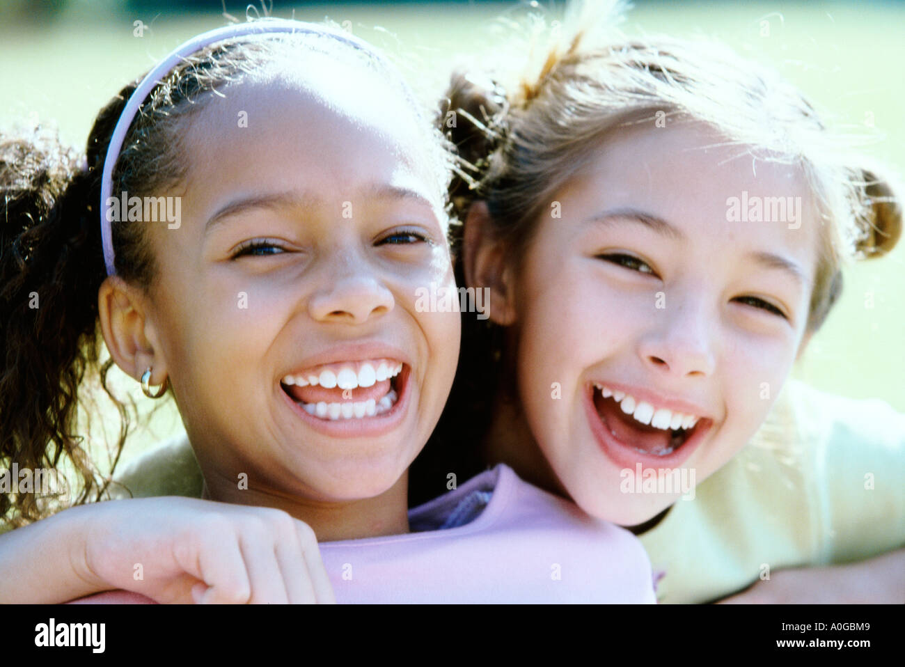 Portrait of two girls smiling Stock Photo - Alamy