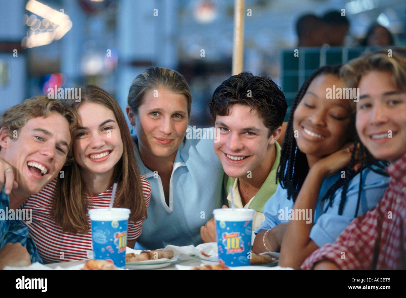 Portrait of a group of teenagers sitting in a restaurant Stock Photo ...