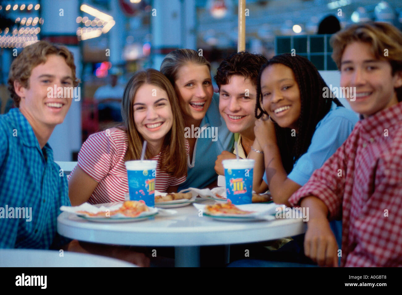 Portrait of a group of teenagers sitting in a restaurant Stock Photo ...