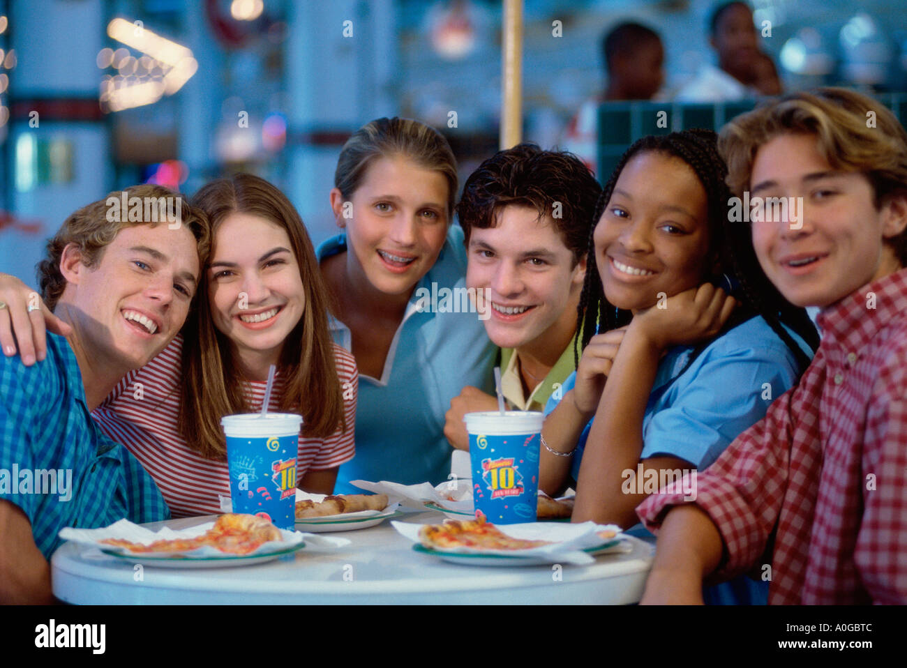 Portrait of a group of teenagers sitting in a restaurant Stock Photo ...