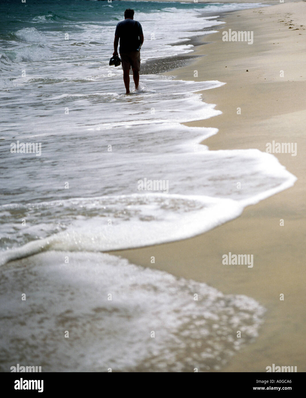 retired man walking surf down beach relax person Stock Photo - Alamy