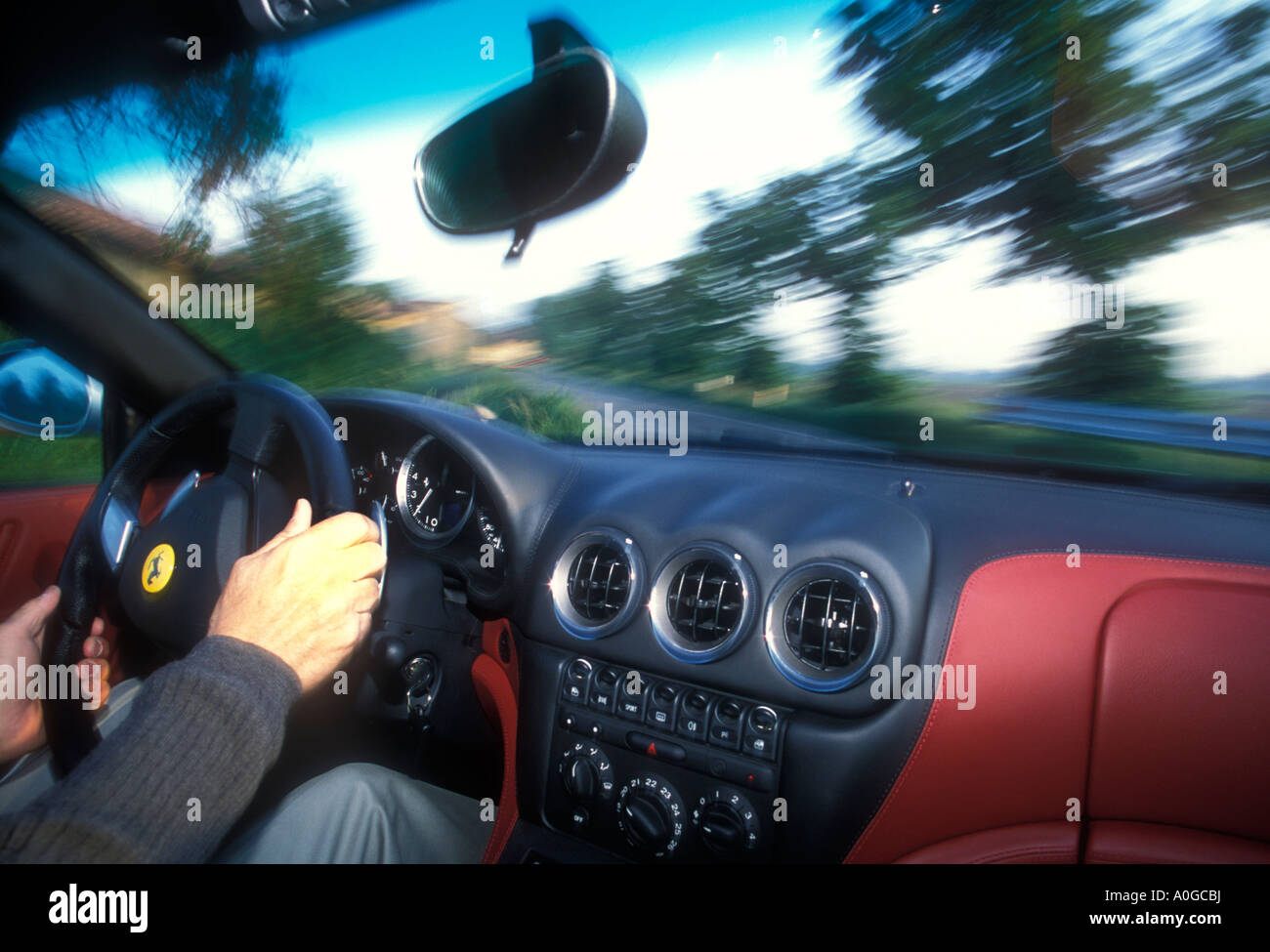 Driving Ferrari at speed Stock Photo - Alamy