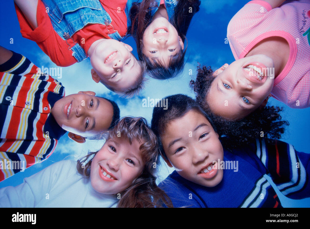 Close-up of a group of children in a huddle Stock Photo - Alamy