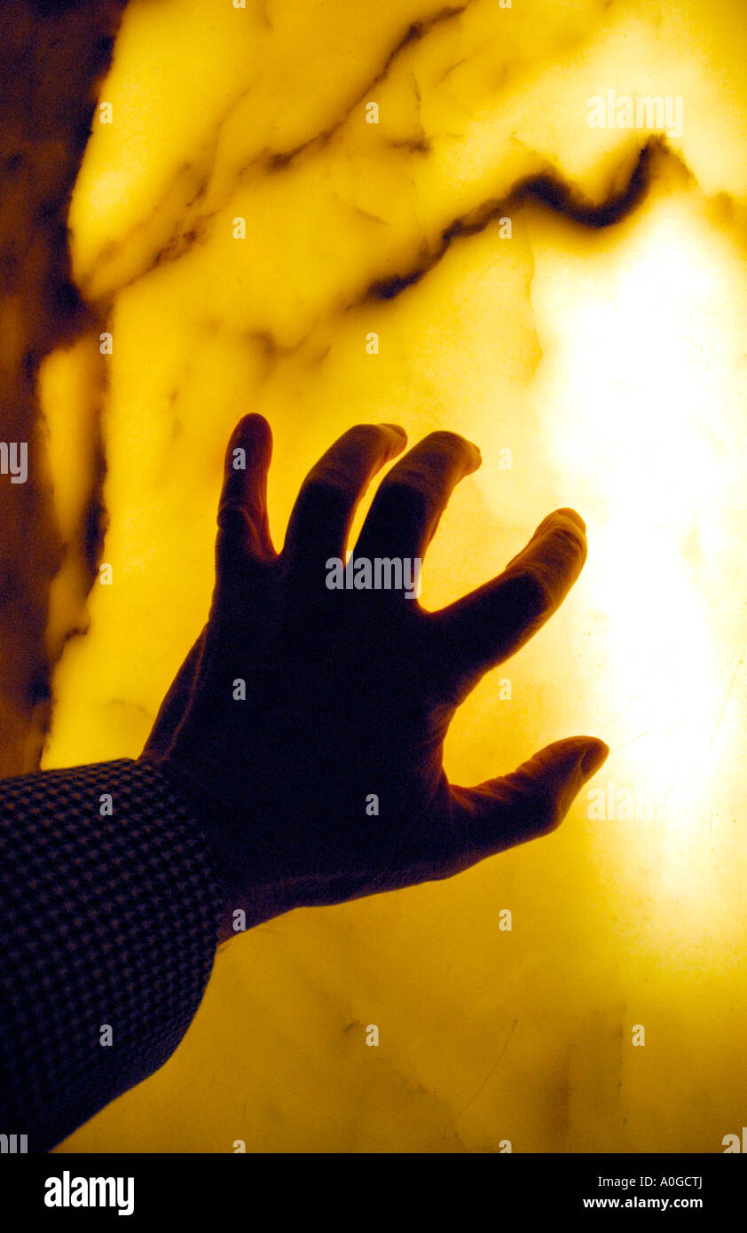 Spooky grasping hand on a light panel Stock Photo - Alamy
