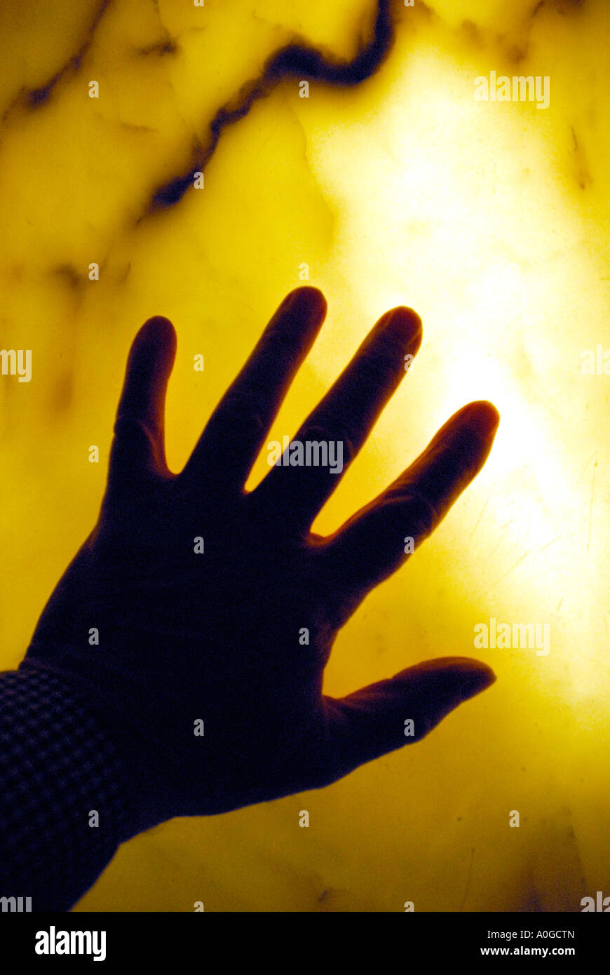 Spooky grasping hand on a light panel Stock Photo - Alamy