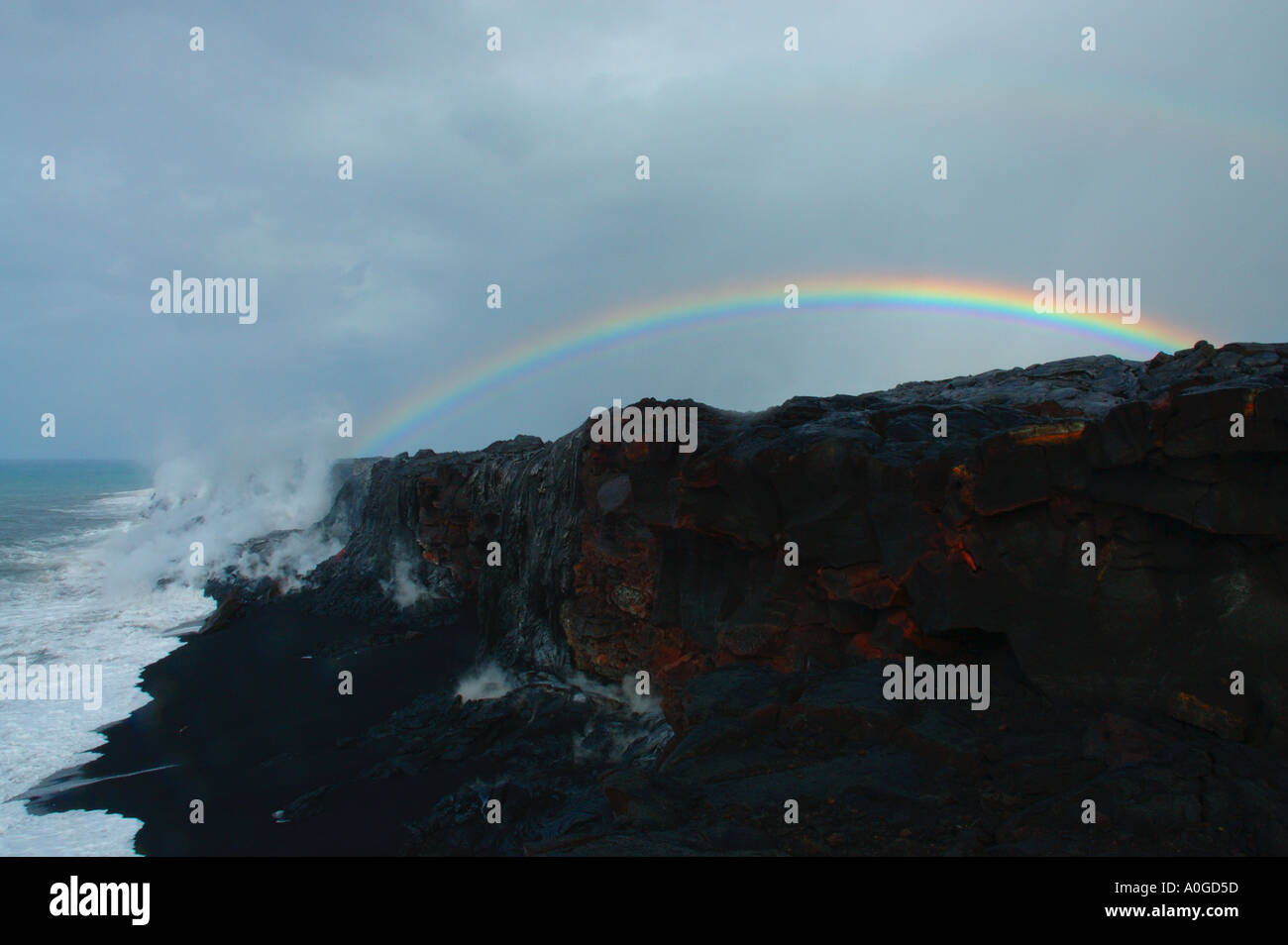 Rainbow and lava flowing into the ocean Hawaii Volcanoes National Park ...
