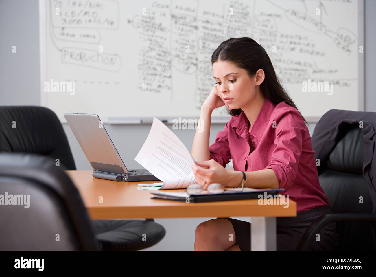 Office worker reading paperwork Stock Photo - Alamy