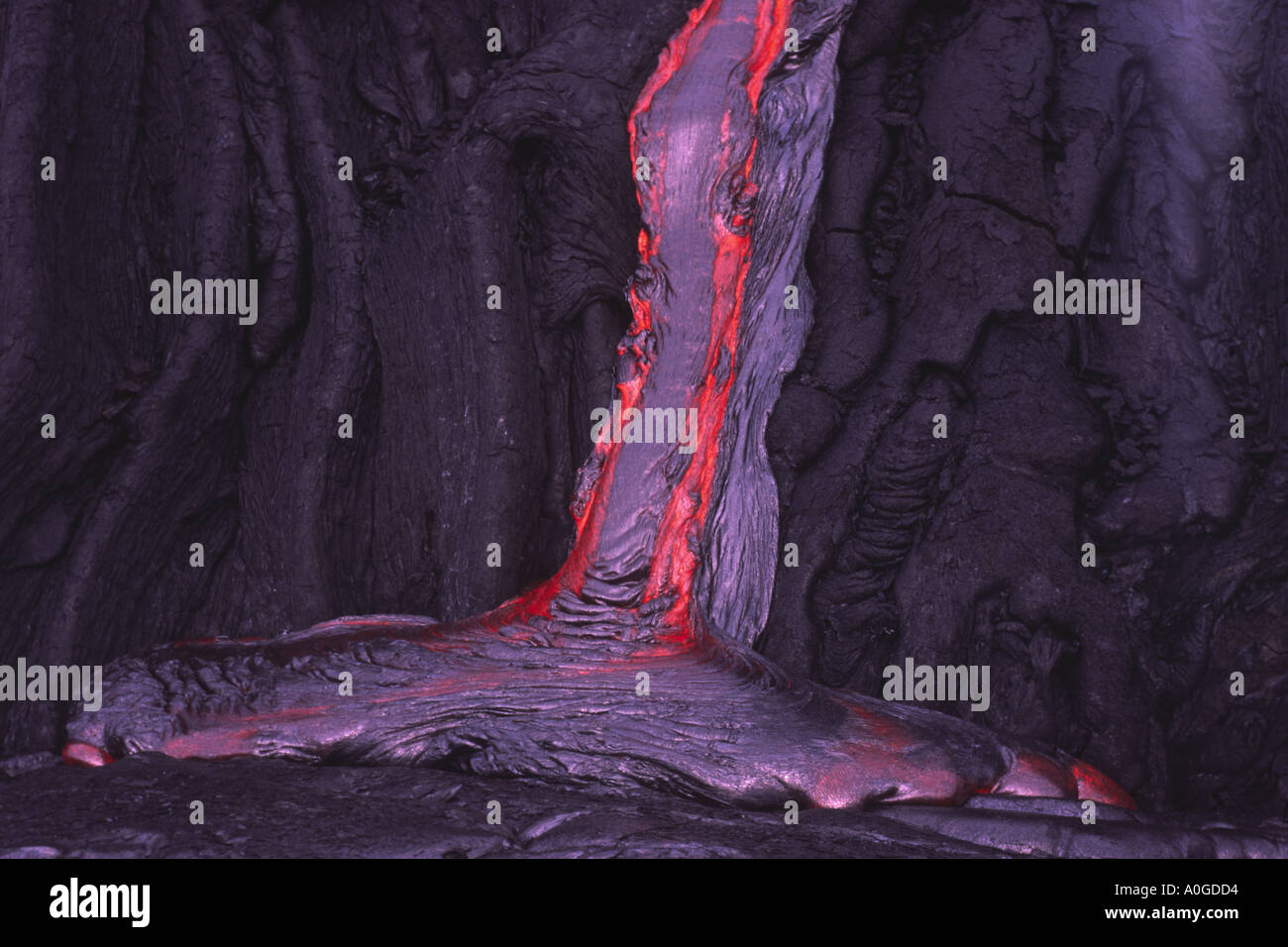Lava pours over an old sea cliff in the early morning rain Volcanoes ...