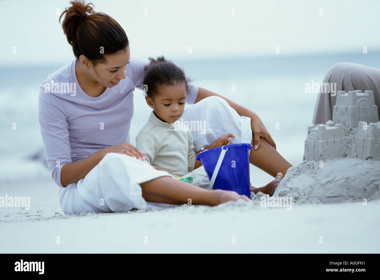 Black girl building sand castle hi-res stock photography and images - Alamy