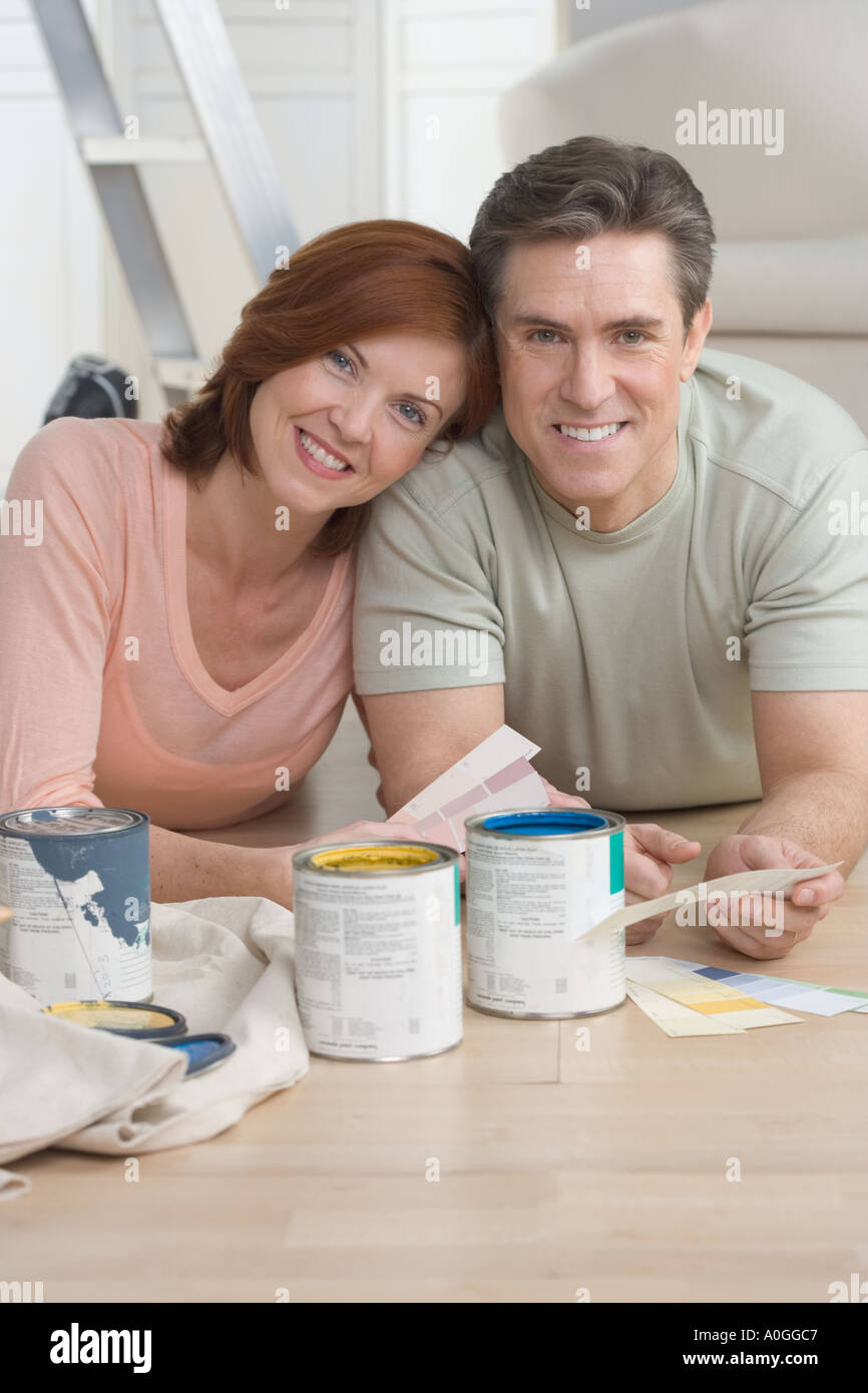 Smiling couple picking out paint colors Stock Photo - Alamy