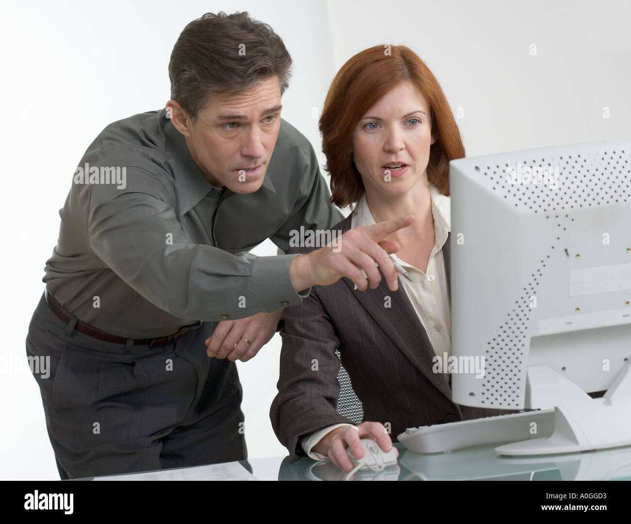 Business people looking at computer screen Stock Photo - Alamy