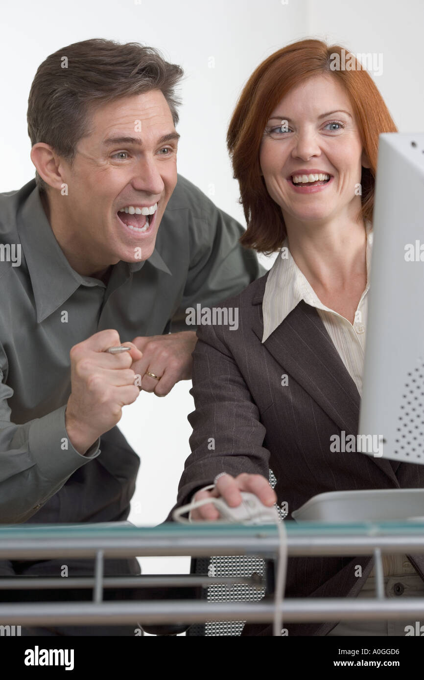 Excited business people at computer Stock Photo - Alamy
