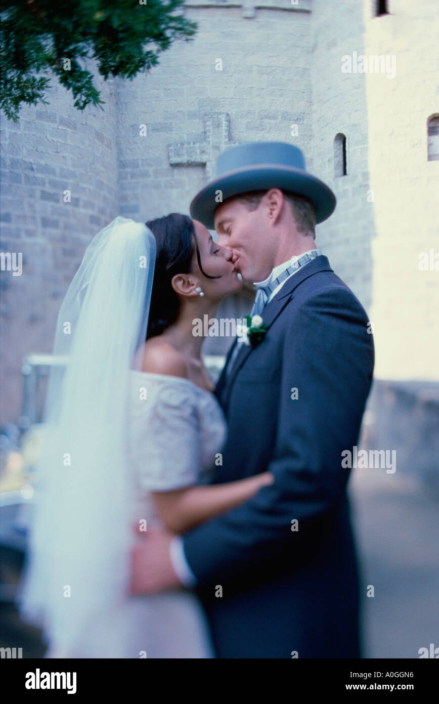 Side profile of a newlywed couple kissing each other Stock Photo - Alamy