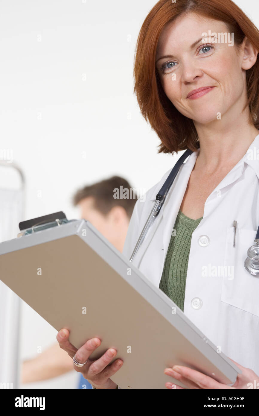 Smiling healthcare professional with chart Stock Photo - Alamy