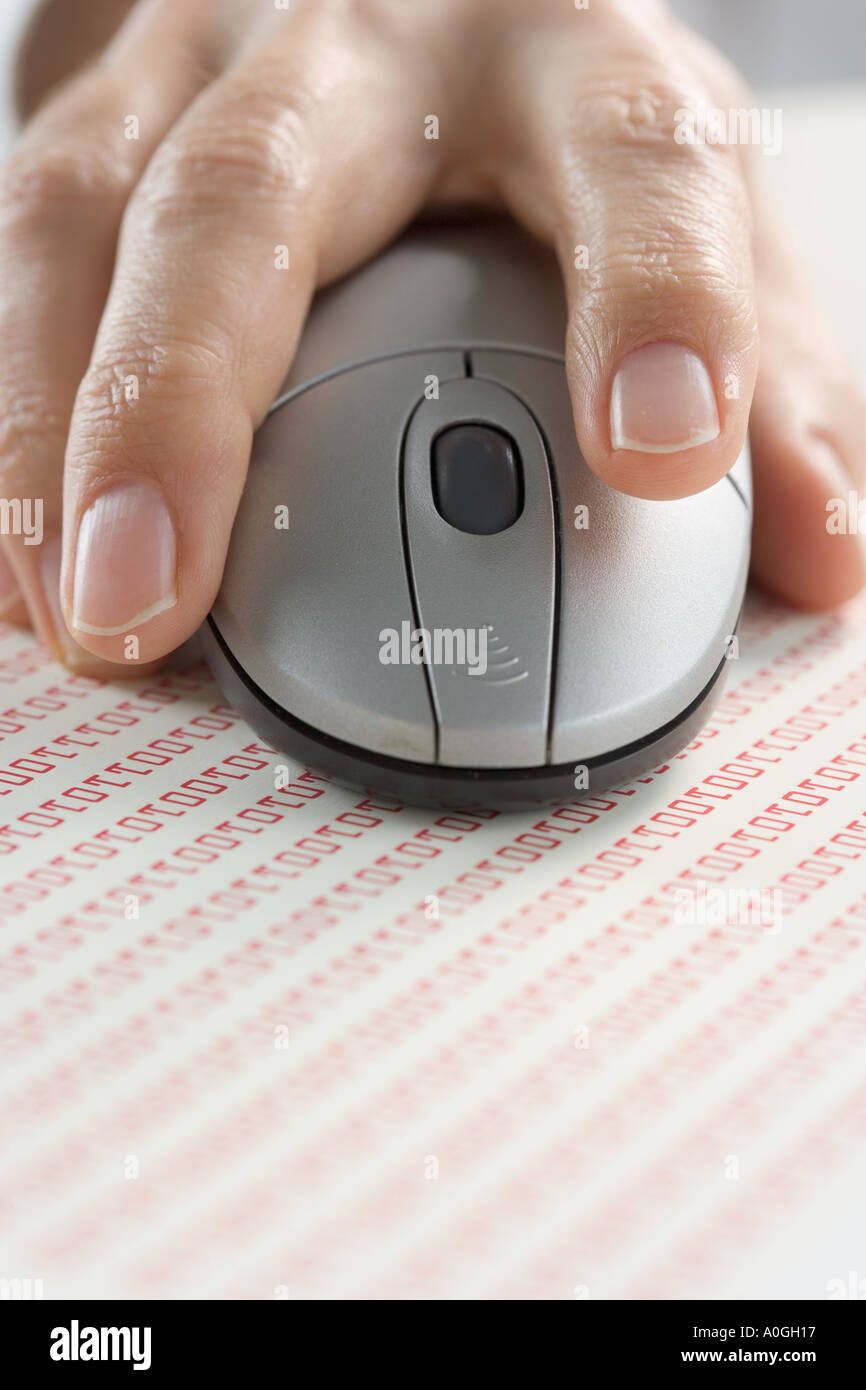 Hand on mouse with binary code Stock Photo - Alamy