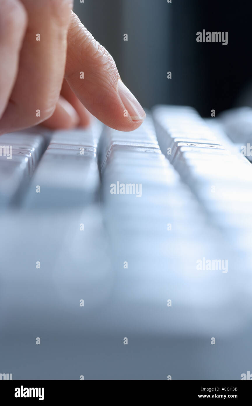Closeup of finger and blurred keyboard Stock Photo - Alamy