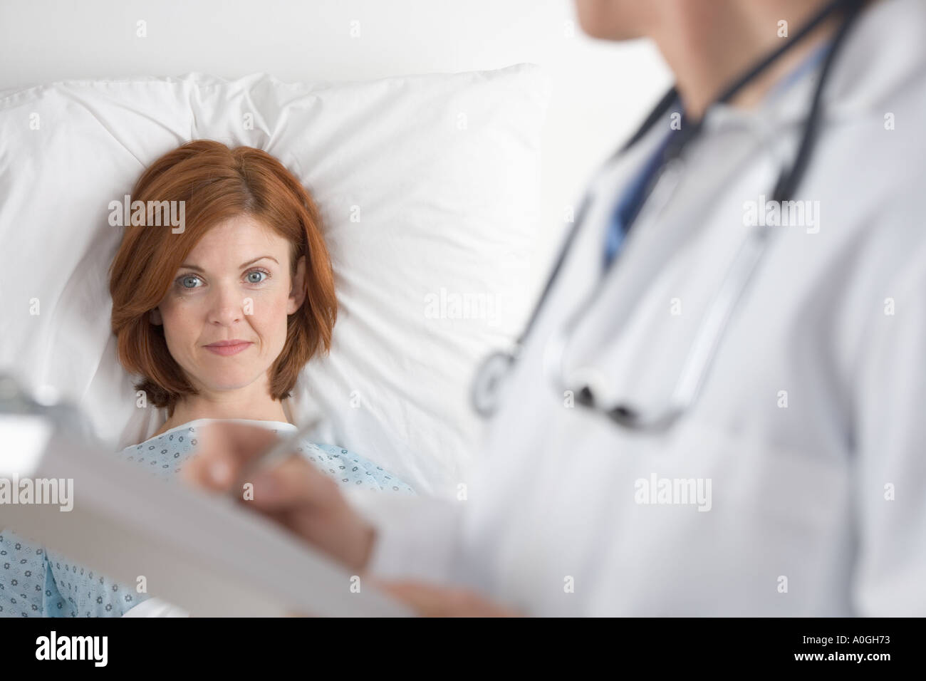 Patient with doctor and chart Stock Photo - Alamy